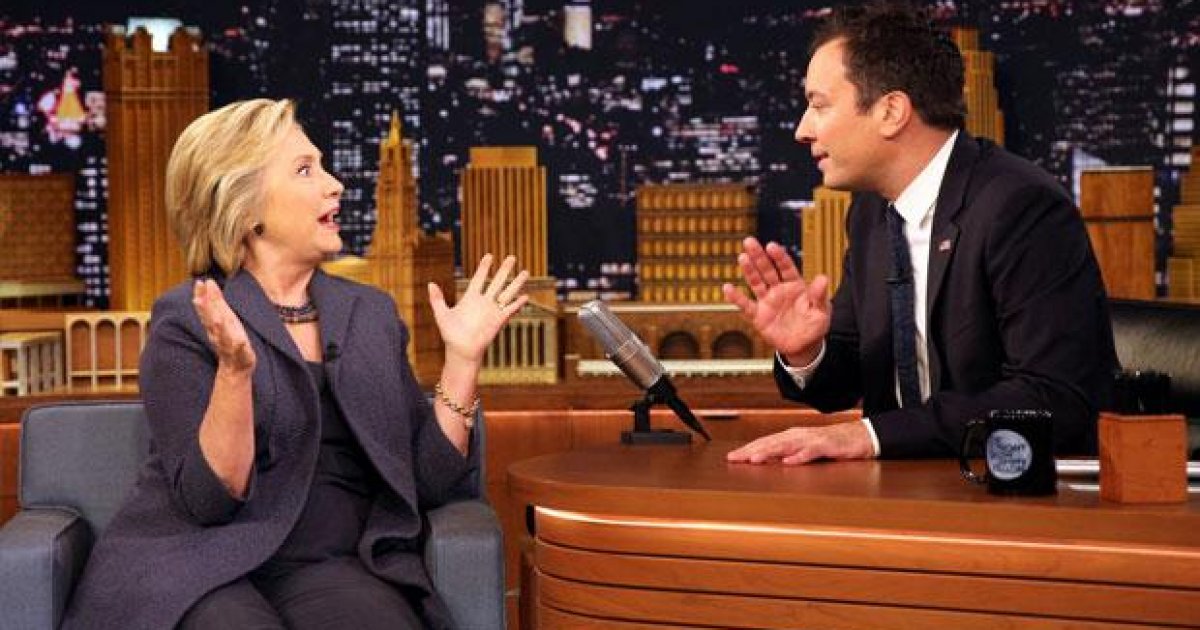 Jimmy Fallon greets Clinton wearing a surgical mask