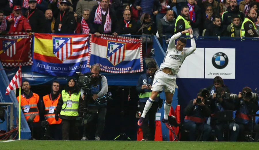 Ronaldo treble sinks Atletico, Barca held by nine-man Malaga
